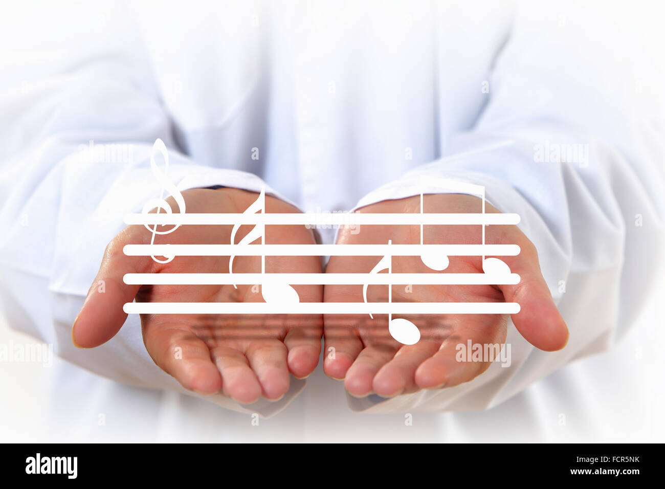 Close up of human hands with music notes figures Stock Photo - Alamy