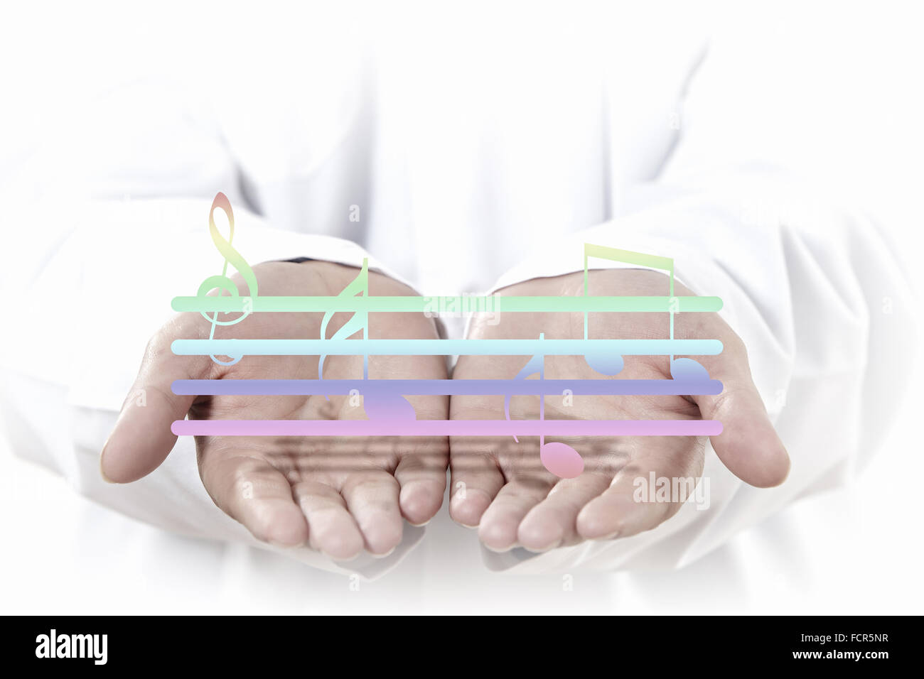 Close up of human hands with music notes figures Stock Photo - Alamy