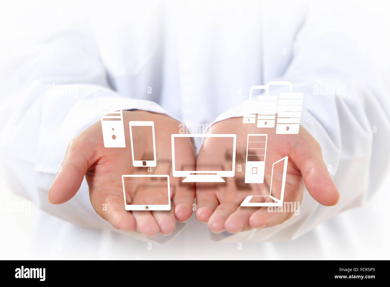 Close up of human hands with device icons Stock Photo - Alamy