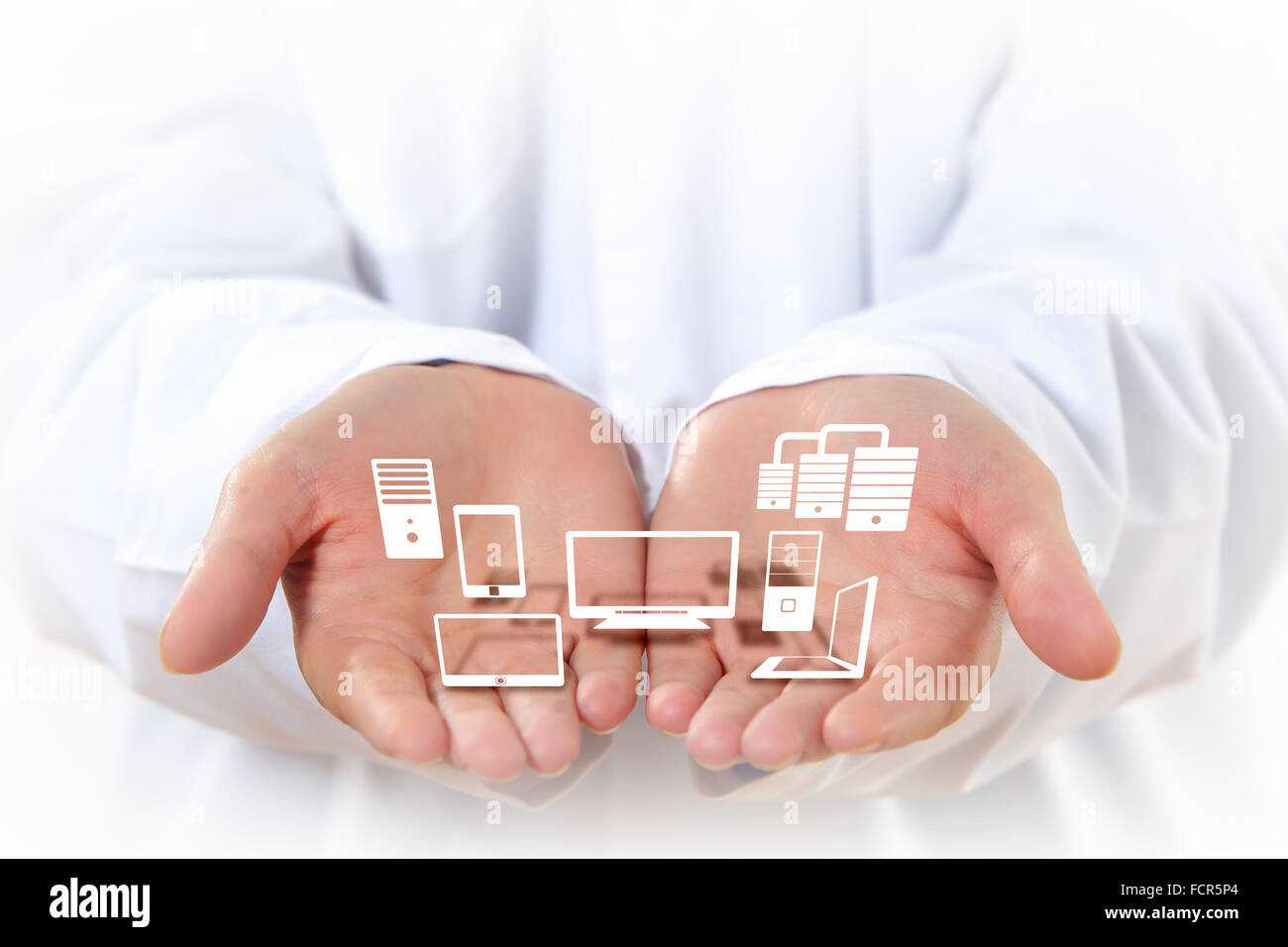 Close up of human hands with device icons Stock Photo - Alamy
