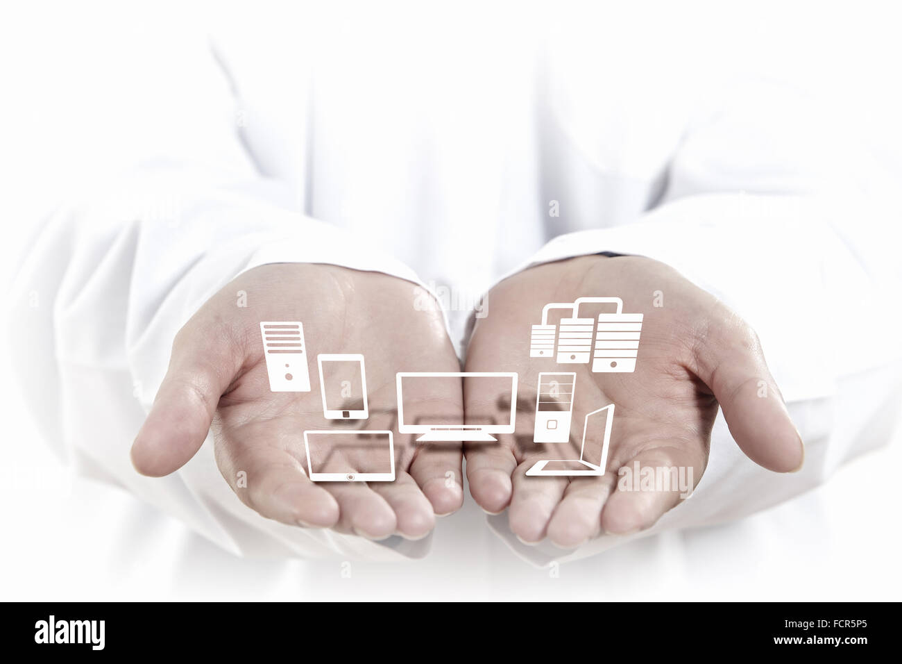 Close up of human hands with device icons Stock Photo - Alamy