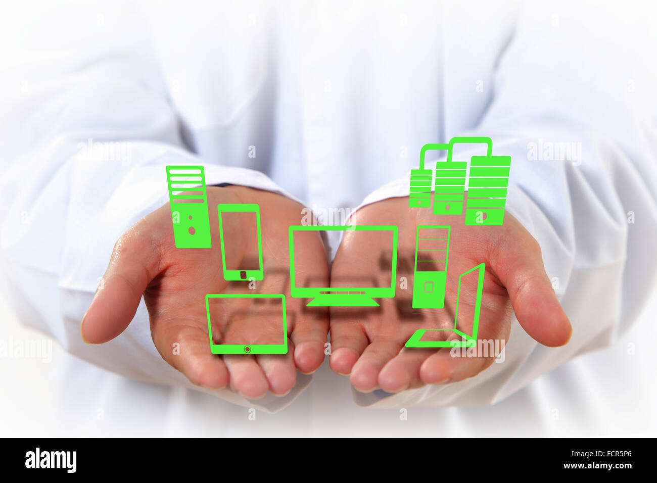 Close up of human hands with device icons Stock Photo - Alamy