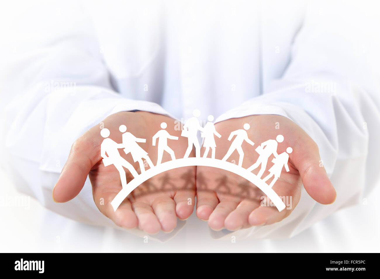 Close up of human hands with row of people figures Stock Photo - Alamy