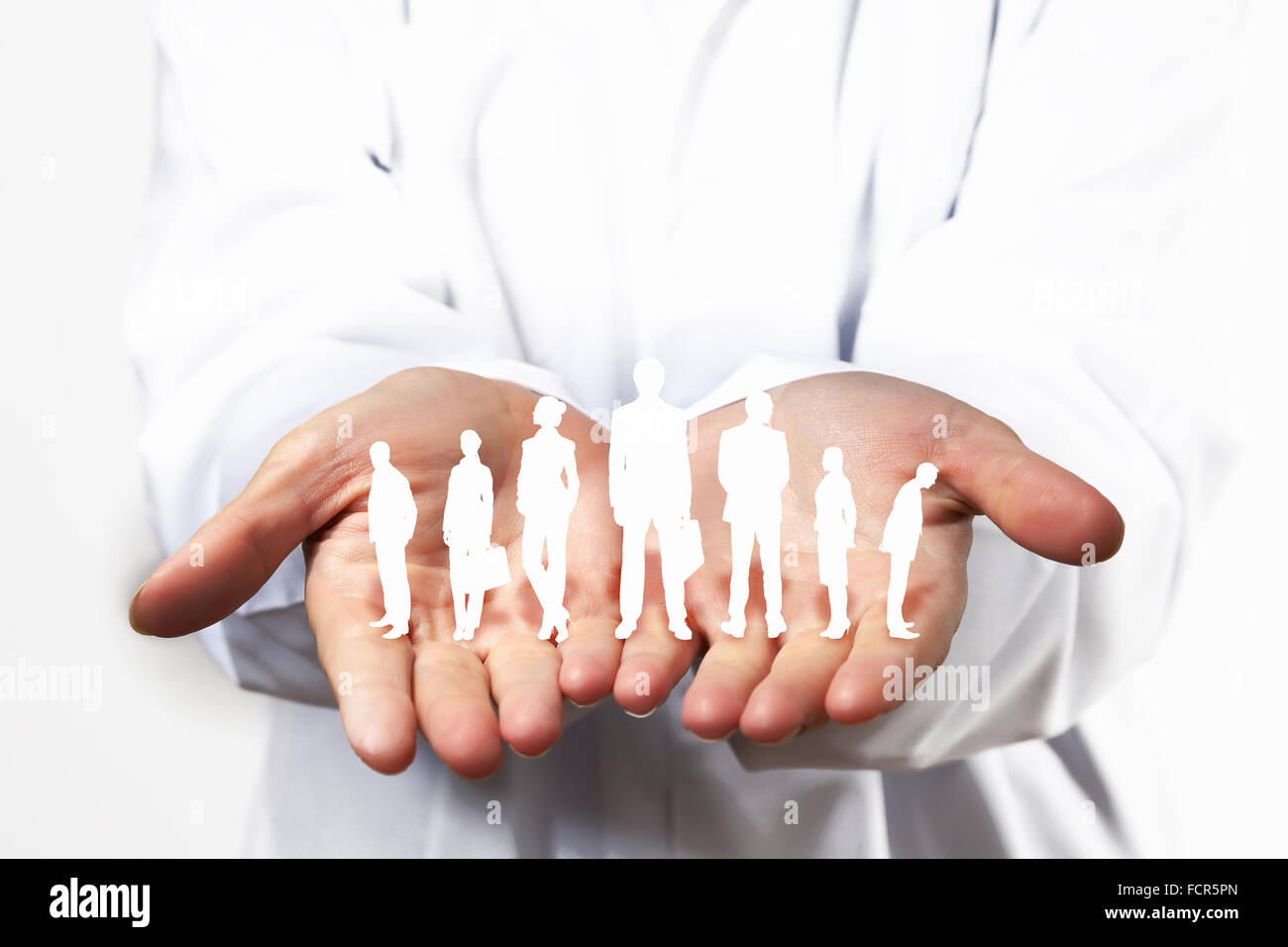 Close up of human hands with row of people figures Stock Photo - Alamy