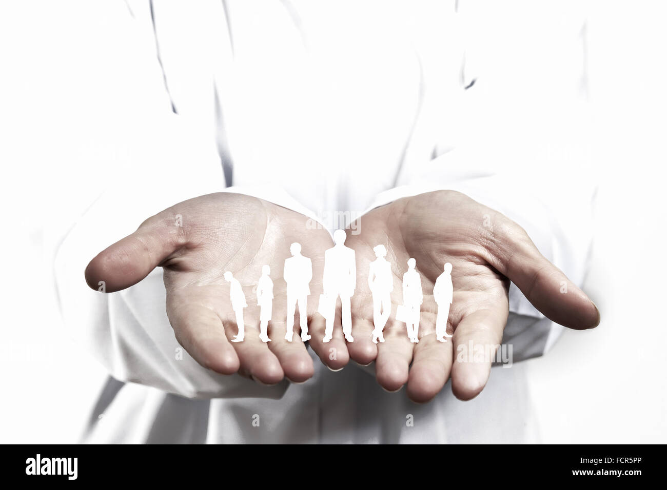 Close up of human hands with row of people figures Stock Photo - Alamy