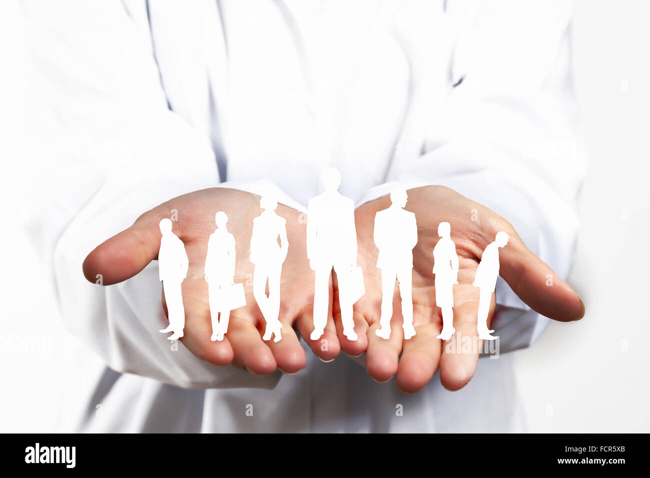 Close up of human hands with row of people figures Stock Photo - Alamy