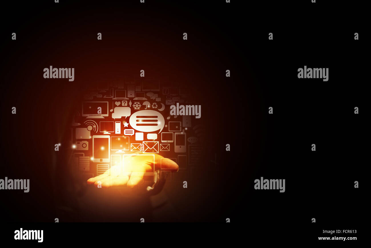 Close up of businessman hand holding collection of media icons Stock ...