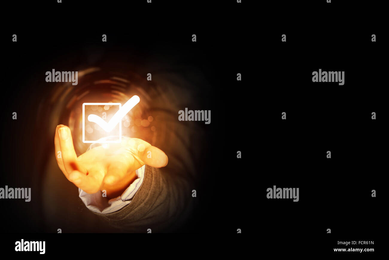Close up of businessman's hand holding check mark icon in palm Stock ...