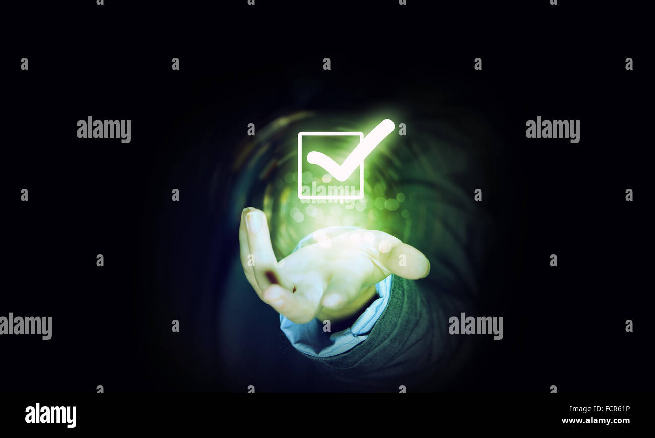 Close up of businessman's hand holding check mark icon in palm Stock ...