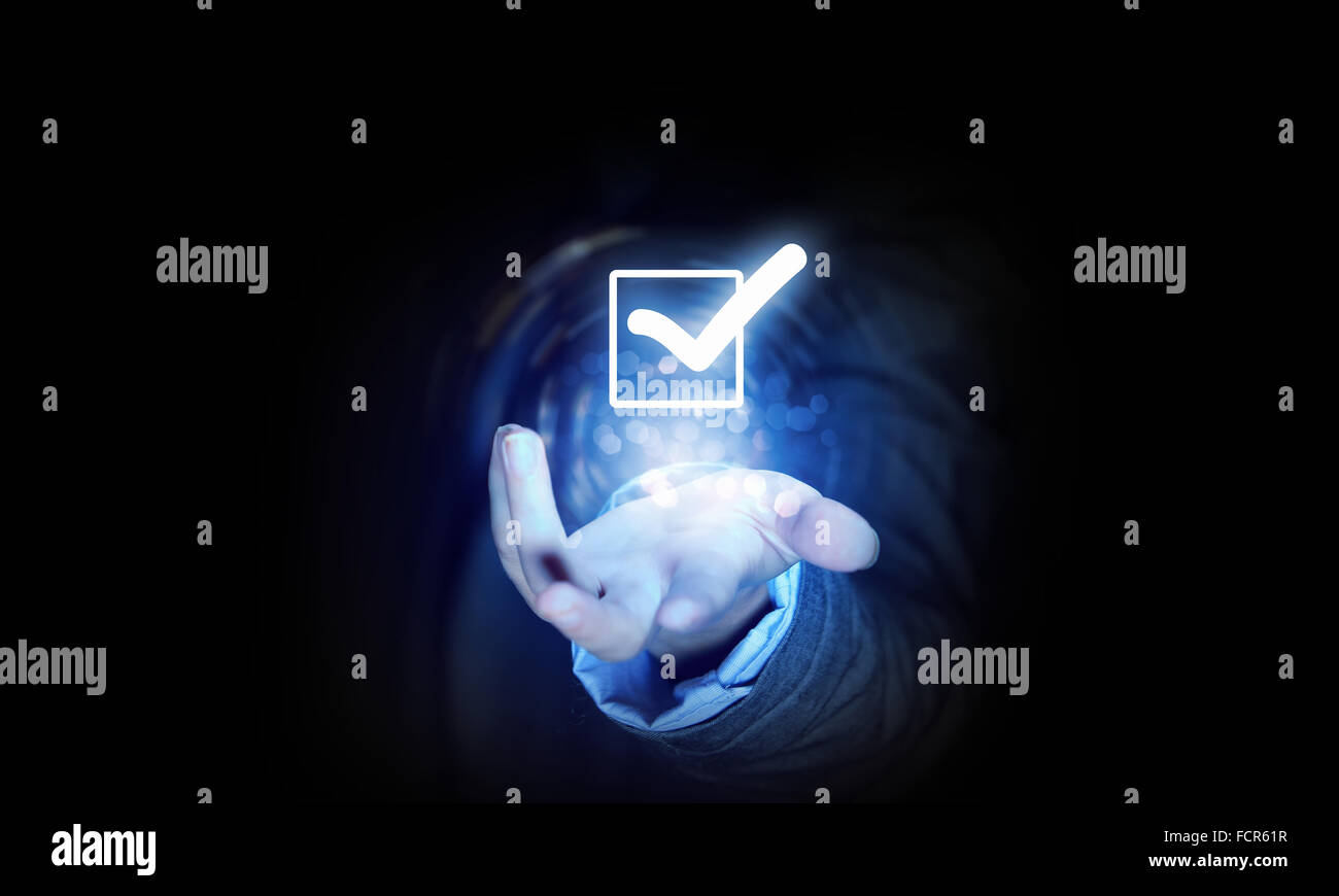Close up of businessman's hand holding check mark icon in palm Stock ...