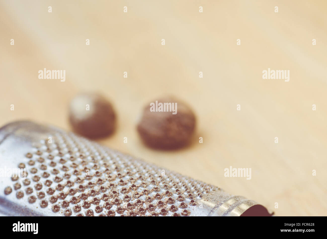 metal nutmeg hand grater and nutmegs on a wood background Stock Photo ...