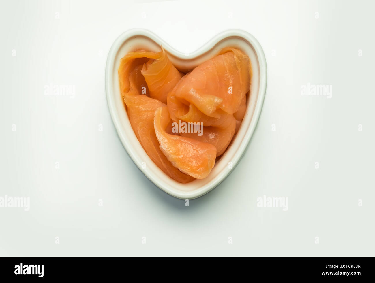 Smoked salmon in a heart shaped bowl Stock Photo - Alamy