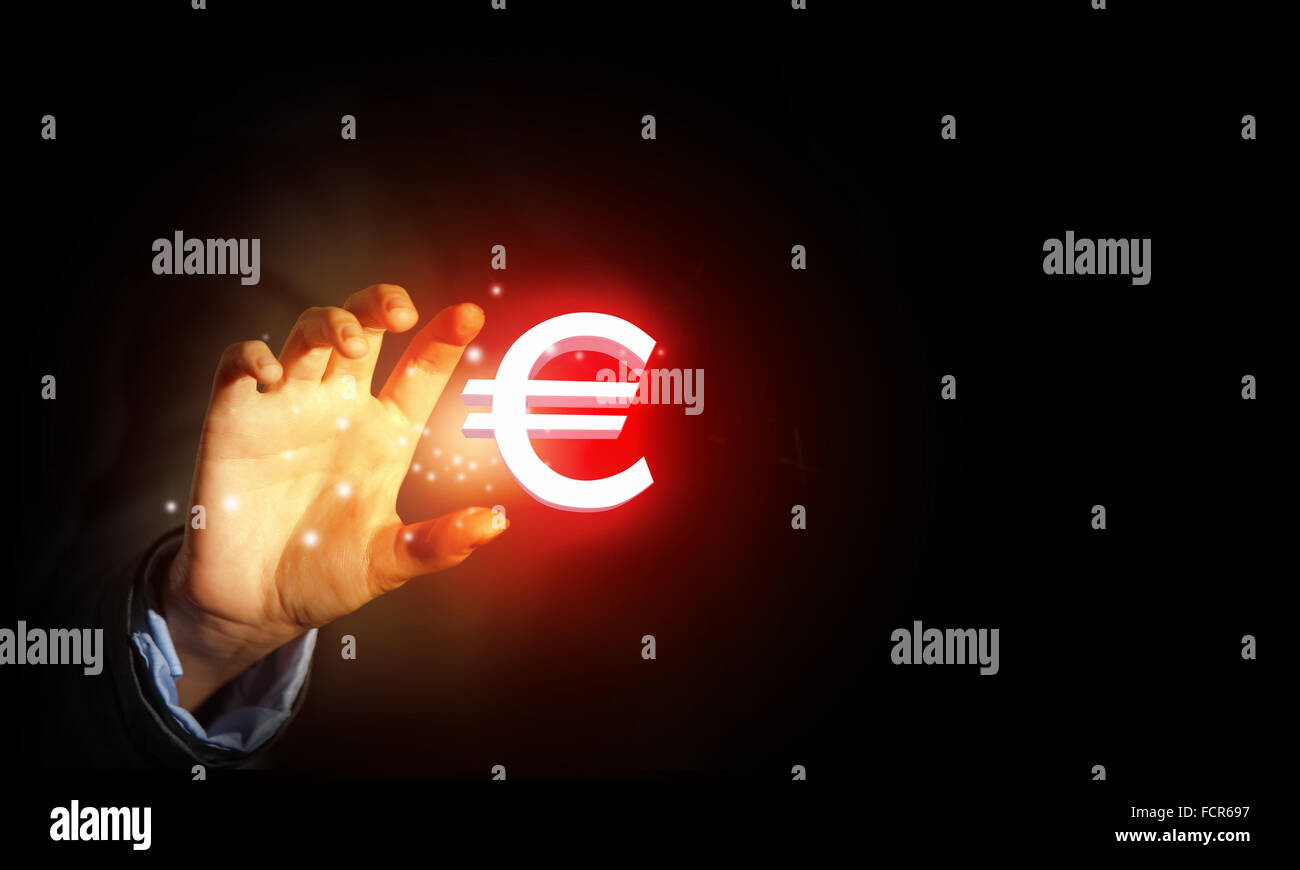 Close up of human hand holding golden euro symbol Stock Photo - Alamy
