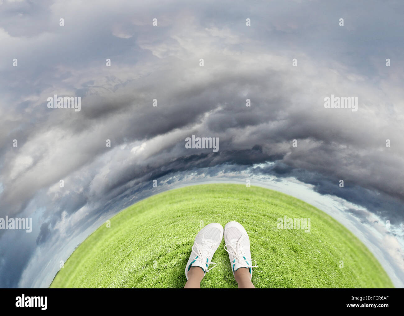 Top view of female feet in white sneakers standing on grass Stock Photo ...