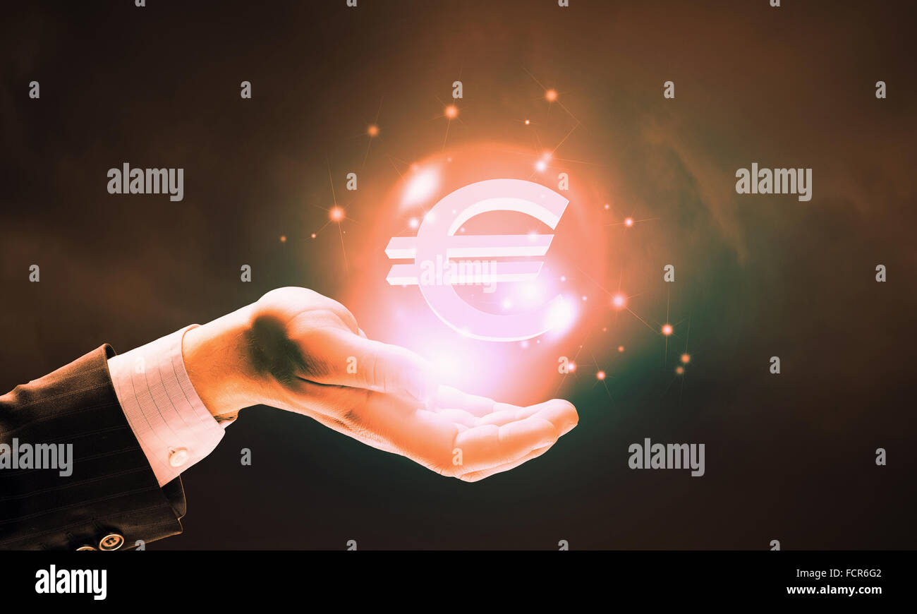 Close up of human hand holding golden euro symbol Stock Photo - Alamy