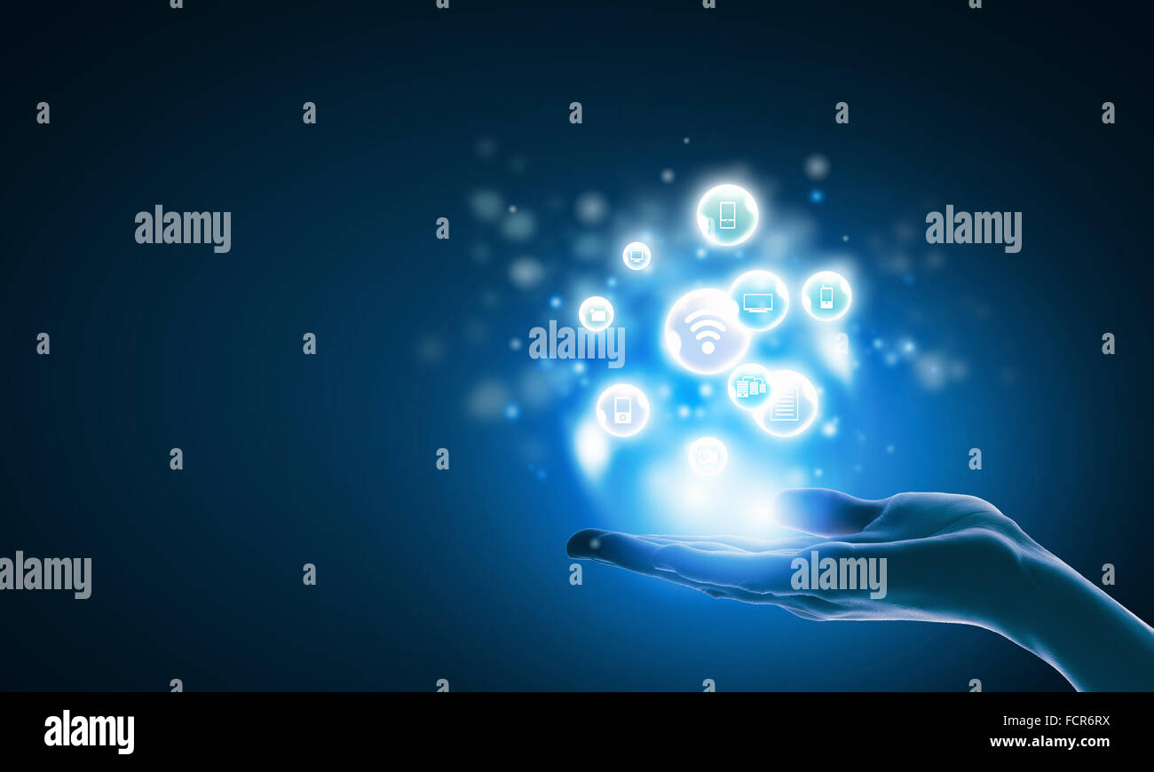 Close up of businessman hand holding collection of media icons Stock ...