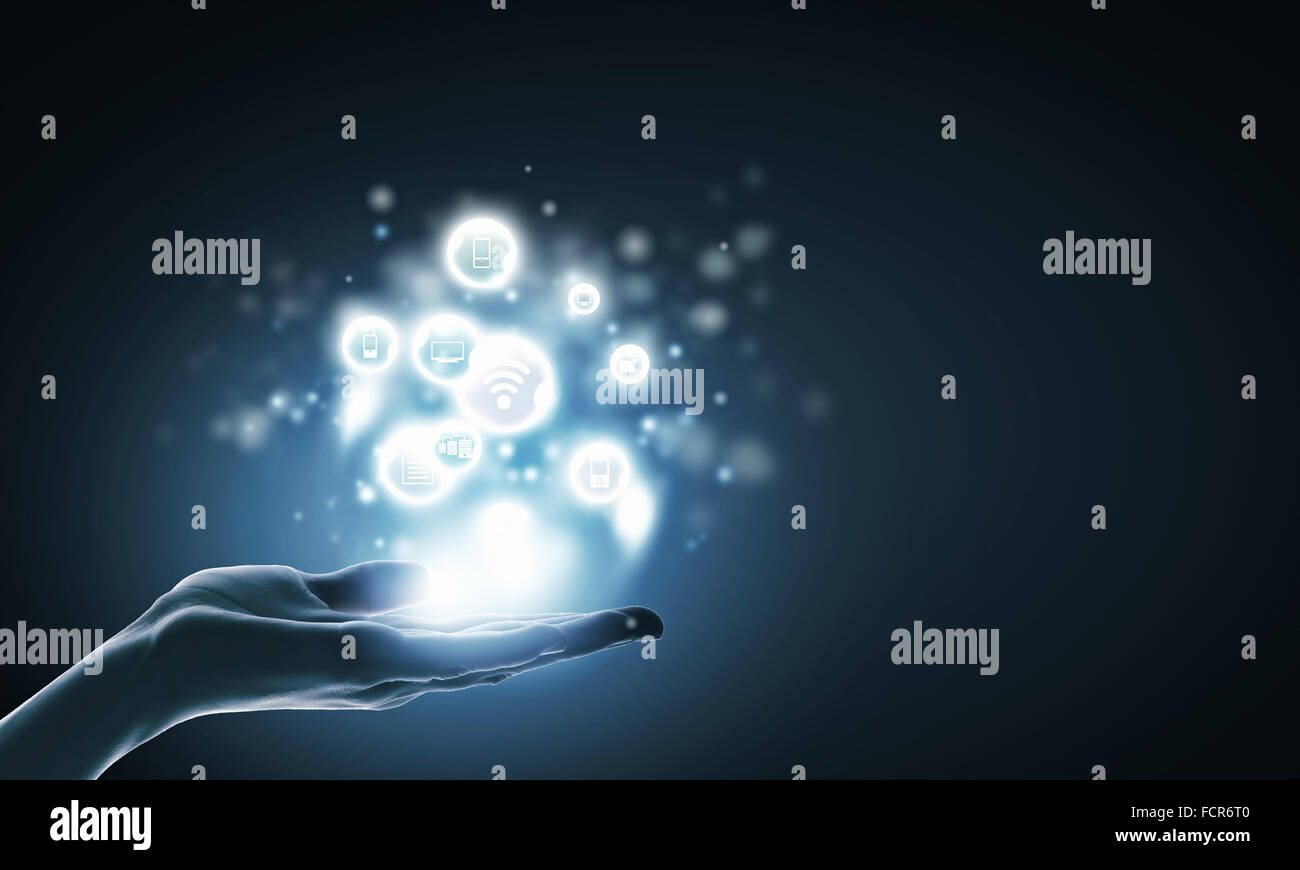 Close up of businessman hand holding collection of media icons Stock ...