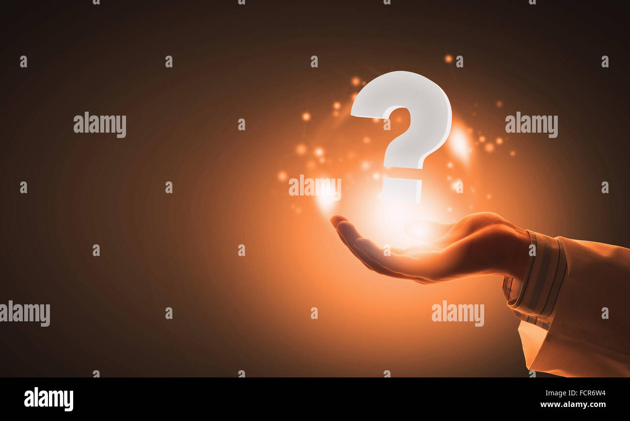 Close up of male hand holding question mark icon Stock Photo - Alamy