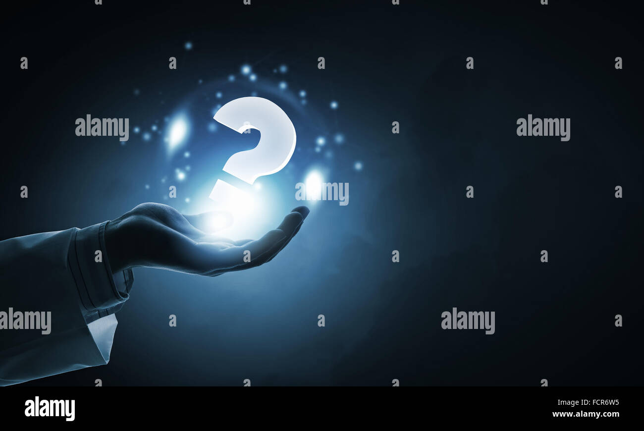 Close up of male hand holding question mark icon Stock Photo - Alamy