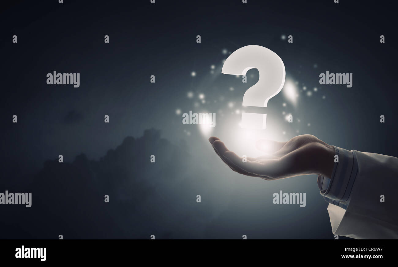 Close up of male hand holding question mark icon Stock Photo - Alamy