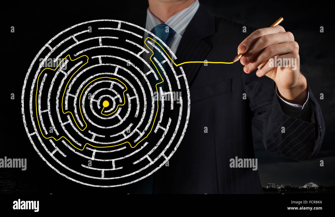 Close up of businessman drawing way out of labyrinth Stock Photo - Alamy