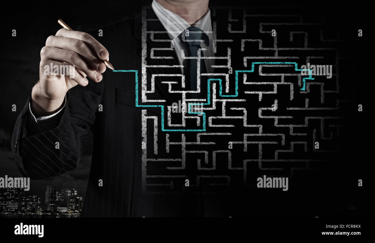 Close up of businessman drawing way out of labyrinth Stock Photo - Alamy