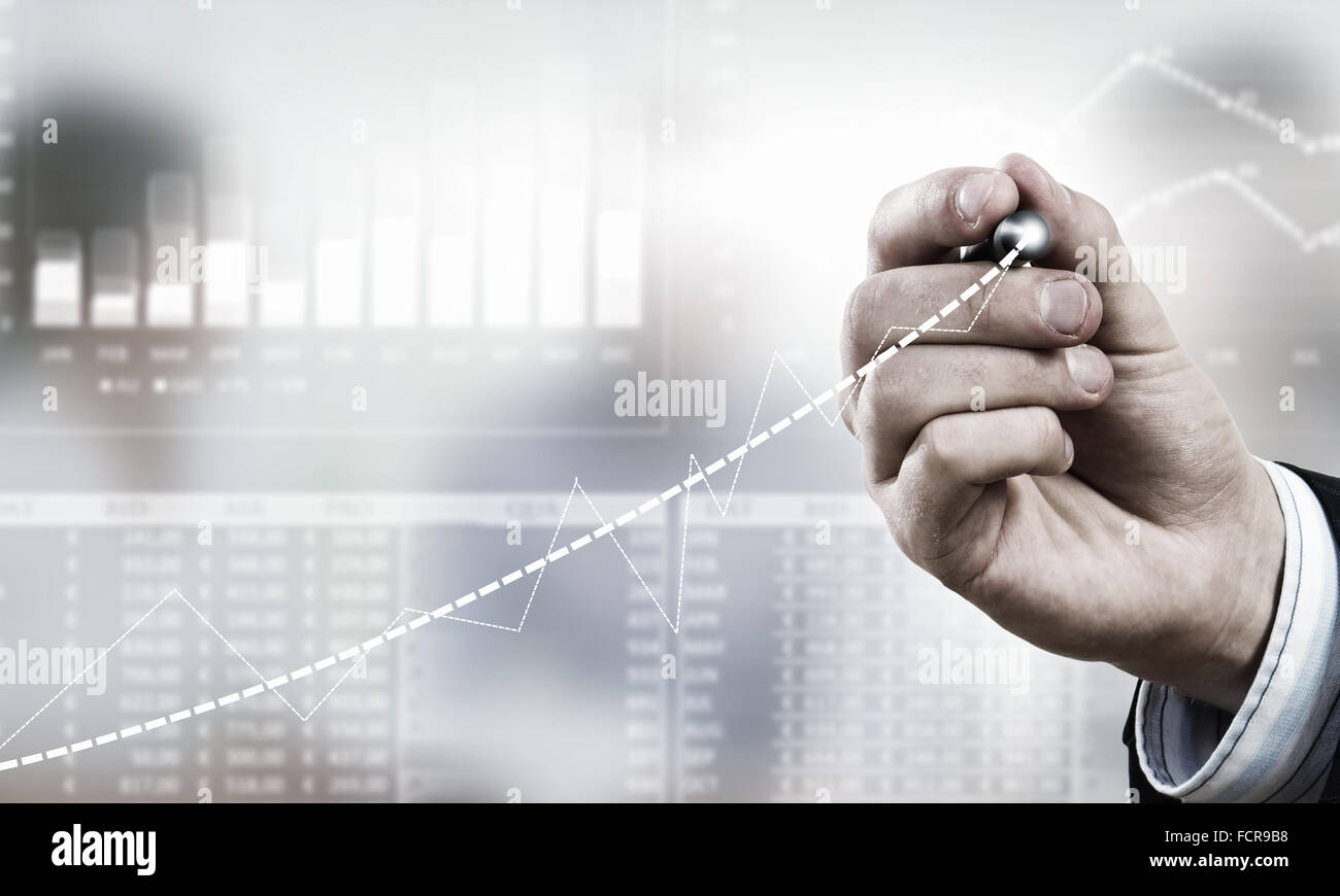 Close up of businessman drawing increasing graph with marker on media ...
