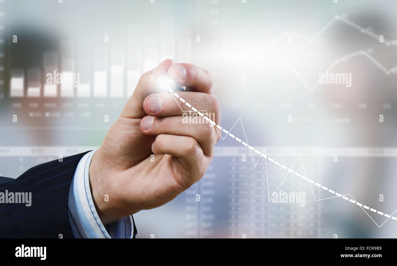 Close up of businessman drawing increasing graph with marker on media ...