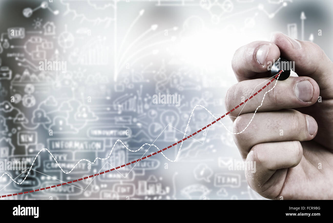 Close up of businessman drawing increasing graph with marker on media ...