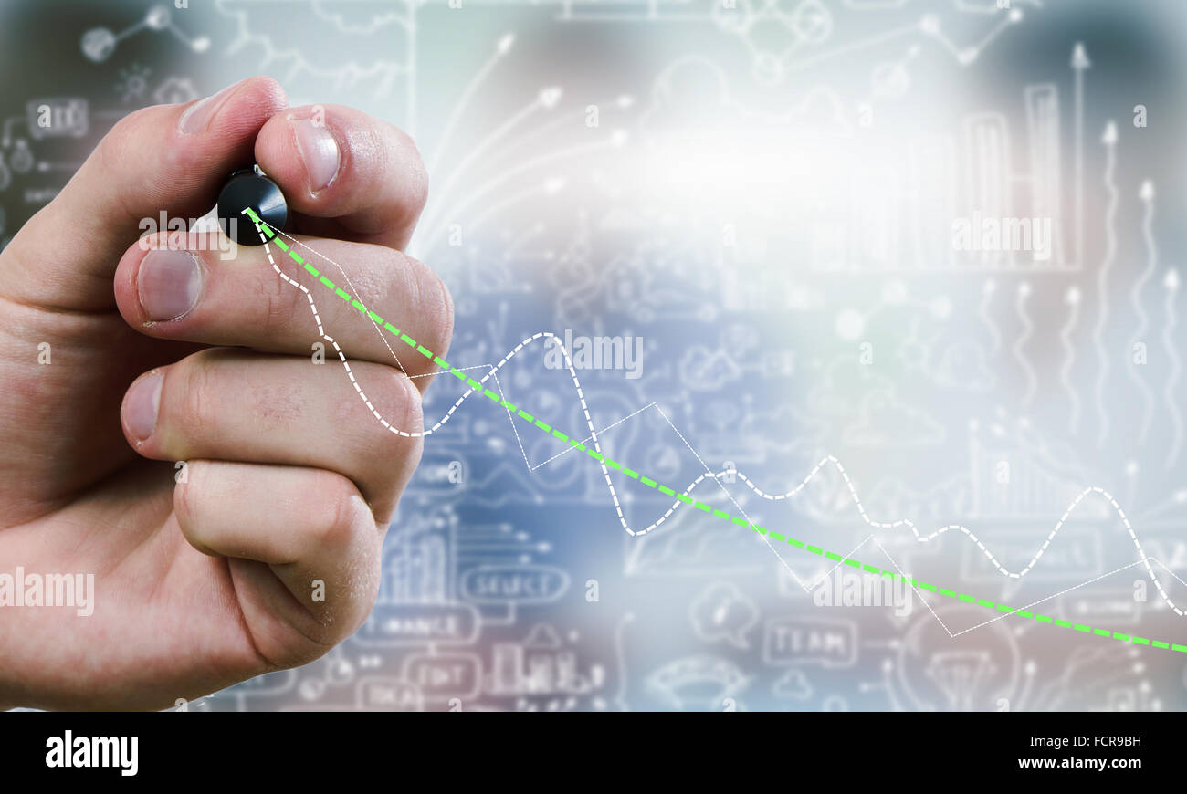 Close up of businessman drawing increasing graph with marker on media ...