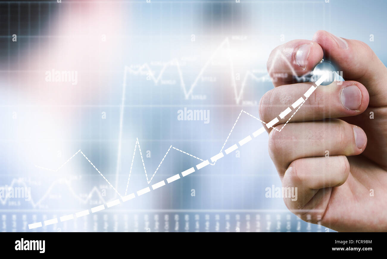 Close up of businessman drawing increasing graph with marker on media ...