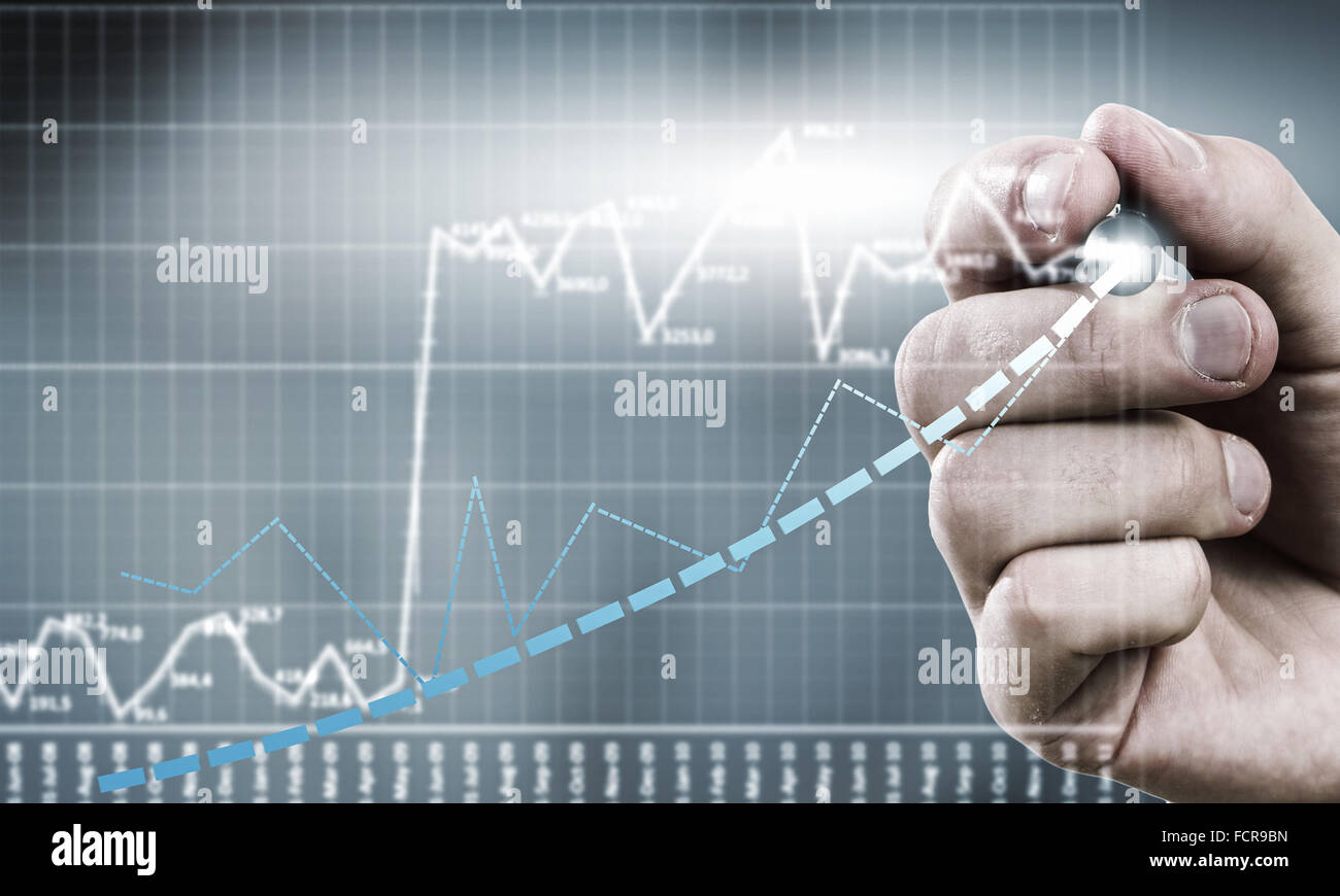 Close up of businessman drawing increasing graph with marker on media ...