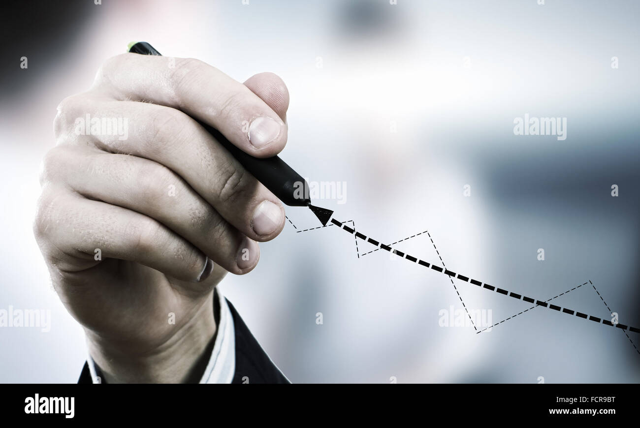 Close up of businessman drawing increasing graph with marker on media ...