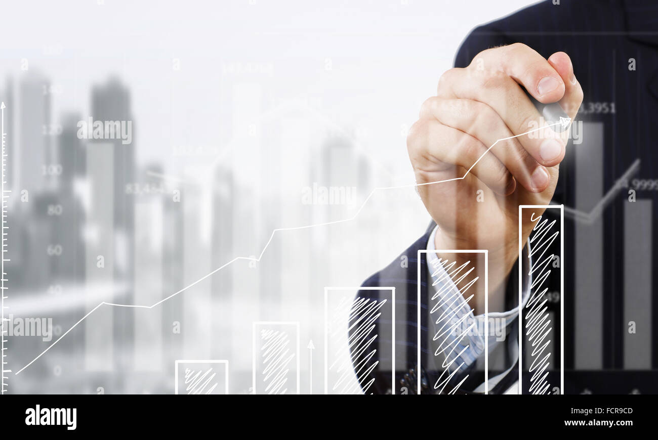 Close up of businessman drawing increasing graph with marker on media ...