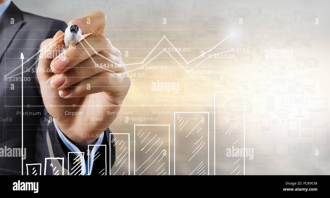 Close up of businessman drawing increasing graph with marker on media ...