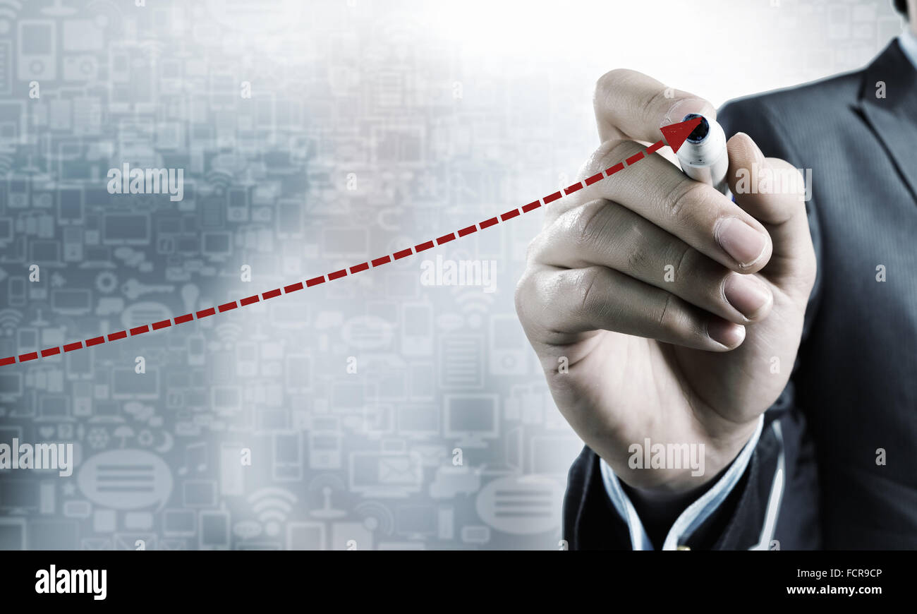 Close up of businessman drawing increasing graph with marker on media ...