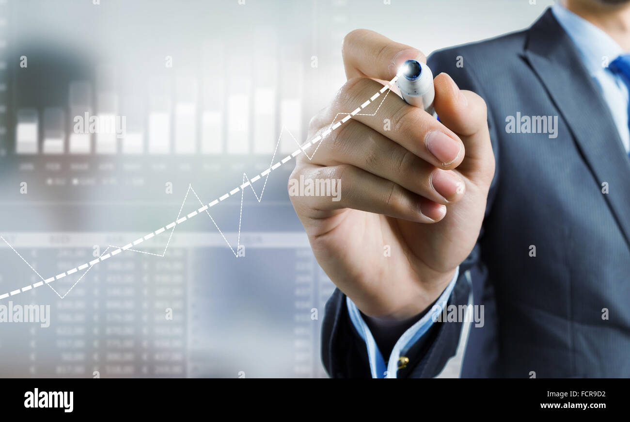 Close up of businessman drawing increasing graph with marker on media ...