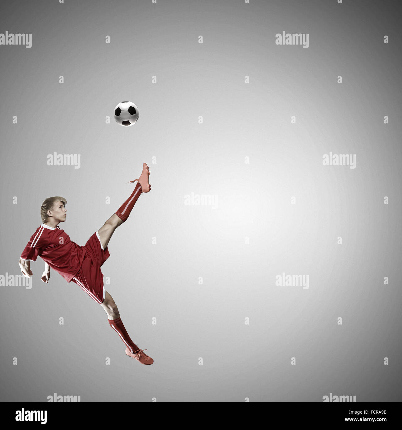Soccer player kicking ball isolated over white background Stock Photo ...