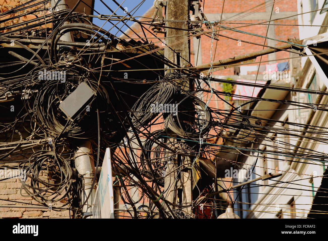 Utility pole and incredible tangle of electric cables with insulators ...