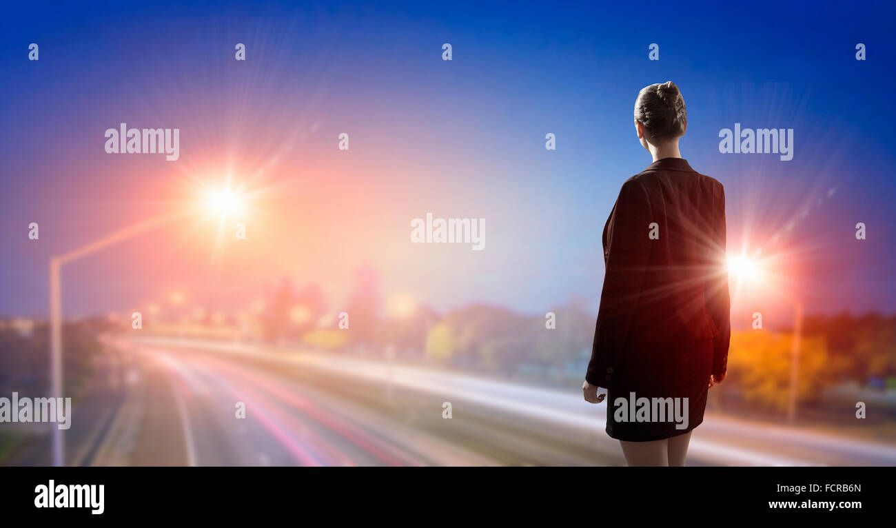 Back view of businesswoman standing on road and looking far away Stock ...