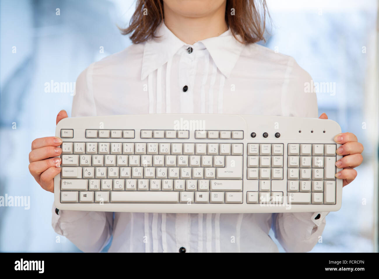 Woman holding keyboard Stock Photo - Alamy
