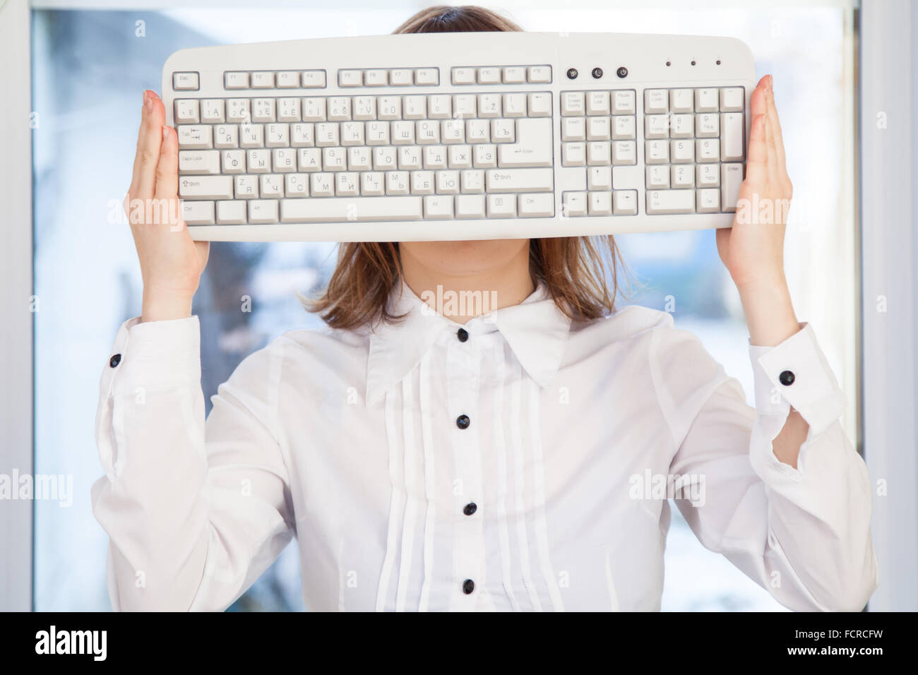 Woman holding keyboard Stock Photo - Alamy