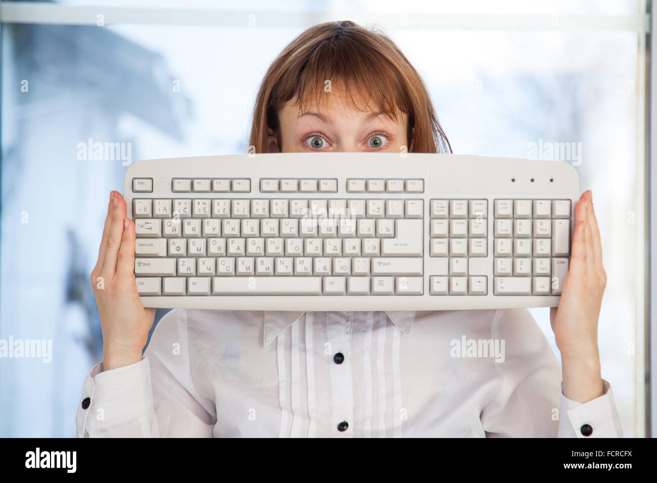 Woman holding keyboard Stock Photo - Alamy