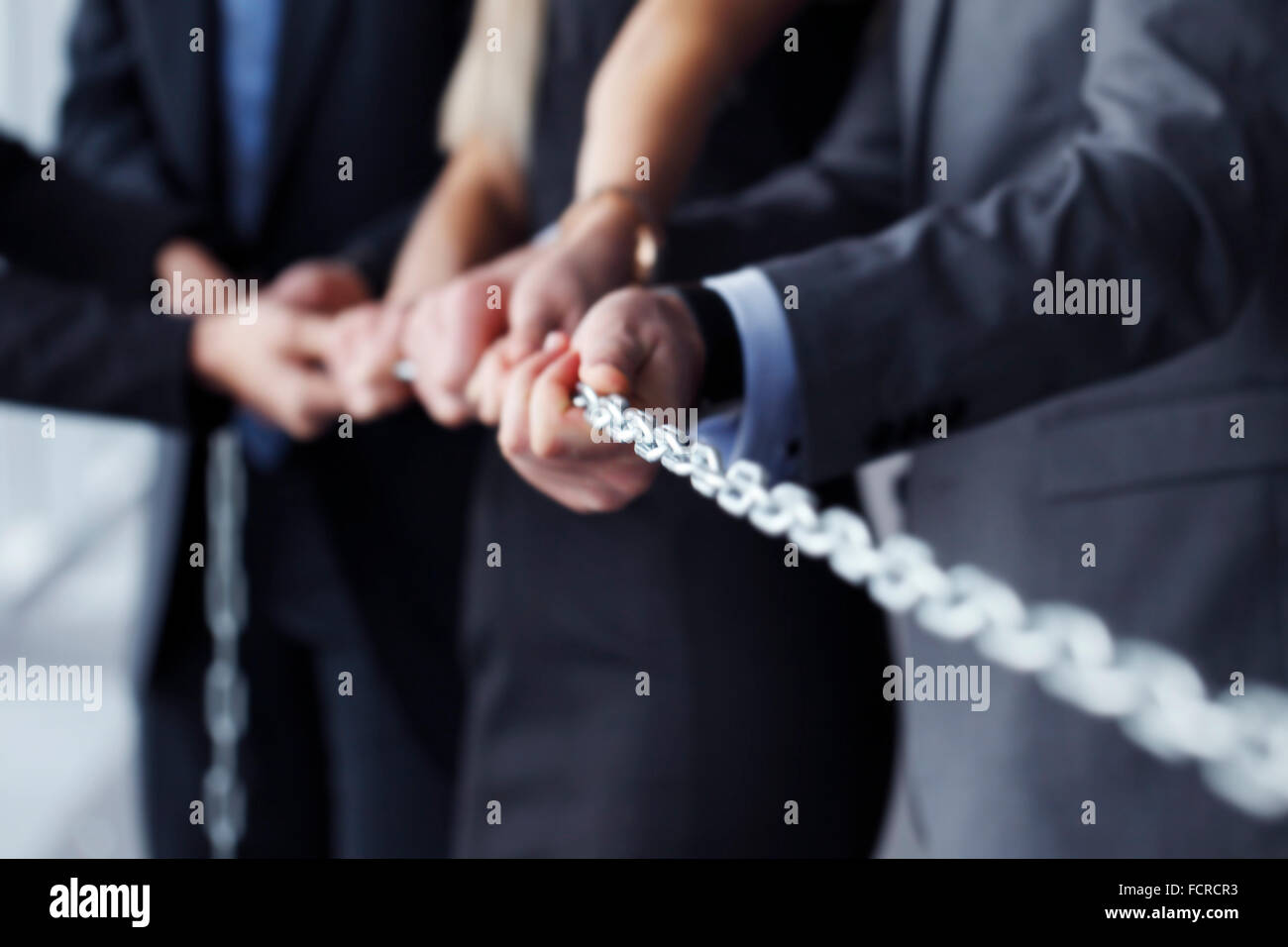 Businessmen pulling chain, teamwork togetherness concept Stock Photo ...