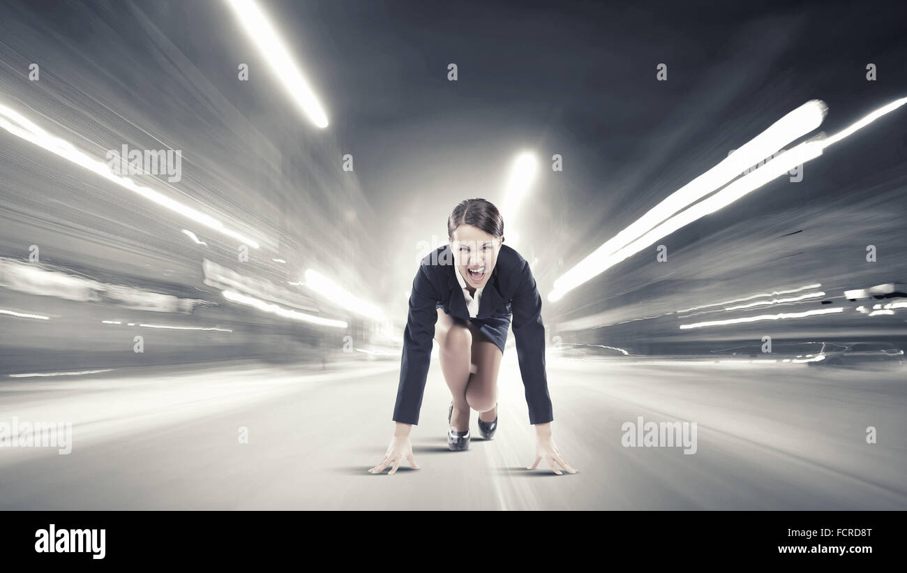 Young determined businesswoman standing in start position Stock Photo ...