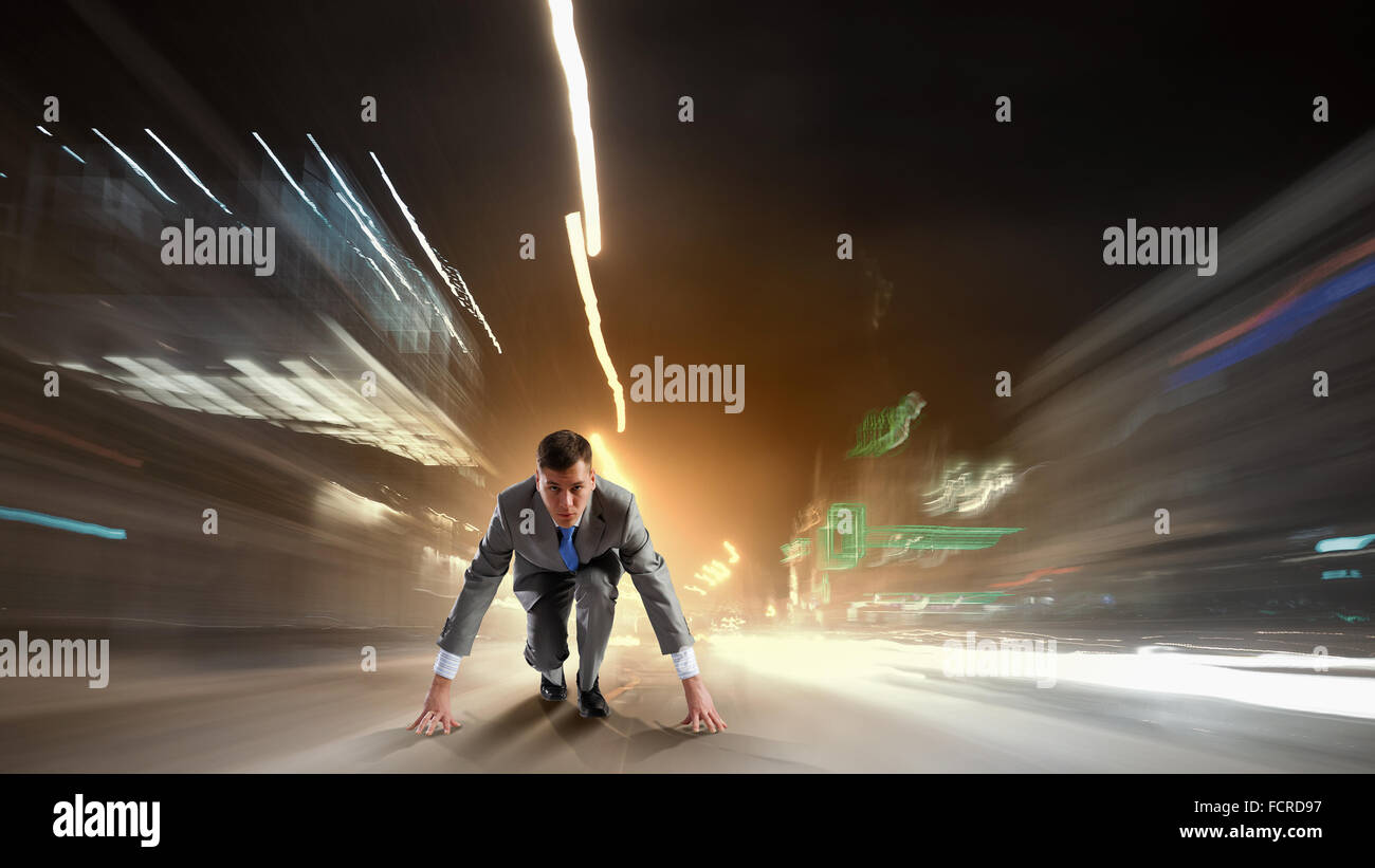 Young determined businessman standing in start position Stock Photo - Alamy