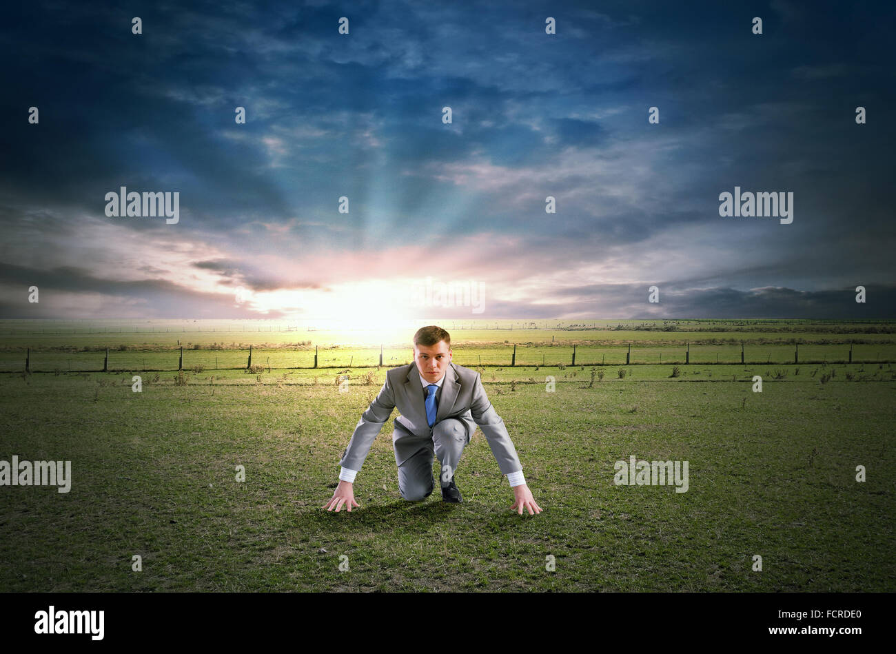 Young determined businessman standing in start position Stock Photo - Alamy