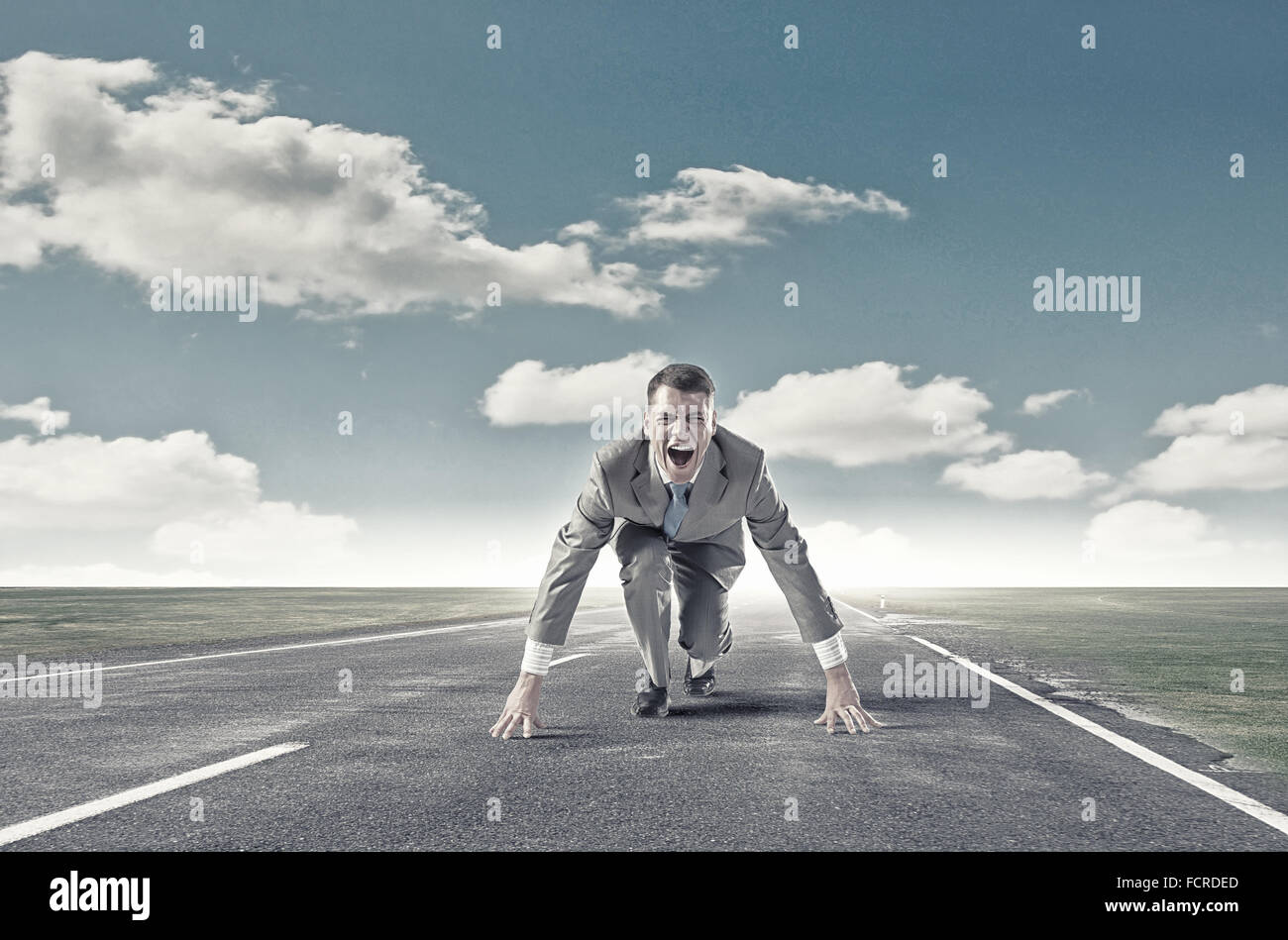 Young determined businessman standing in start position Stock Photo - Alamy