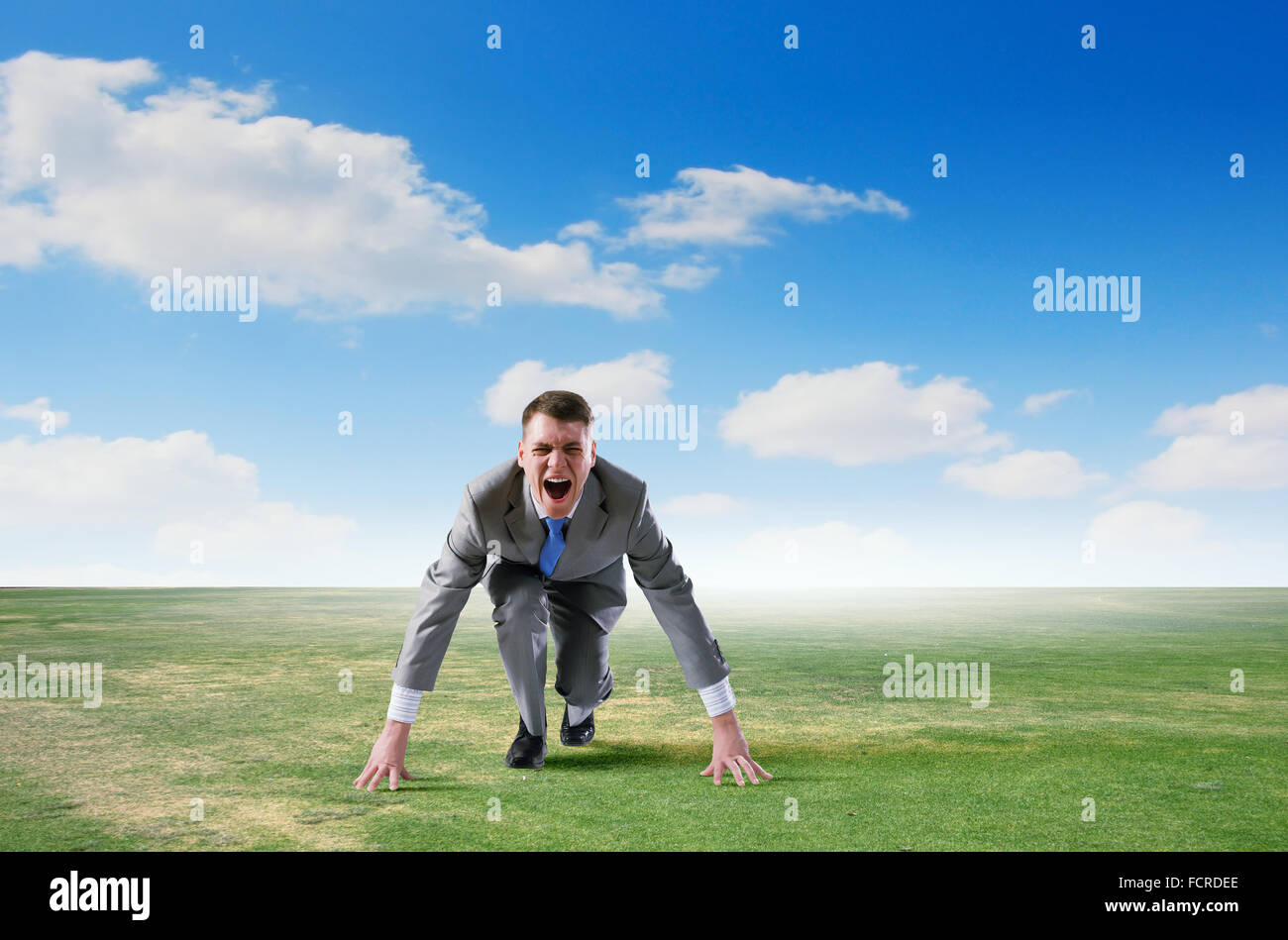 Young determined businessman standing in start position Stock Photo - Alamy