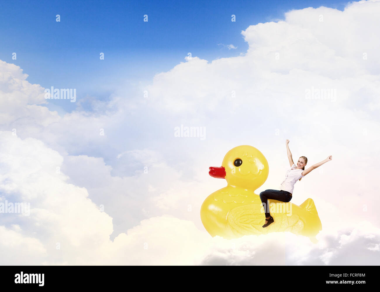Young happy businesswoman riding yellow rubber duck Stock Photo - Alamy